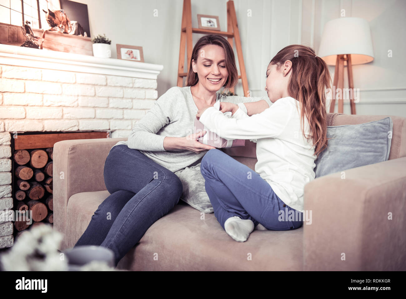 Nice cute girl opening a gift box Stock Photo - Alamy