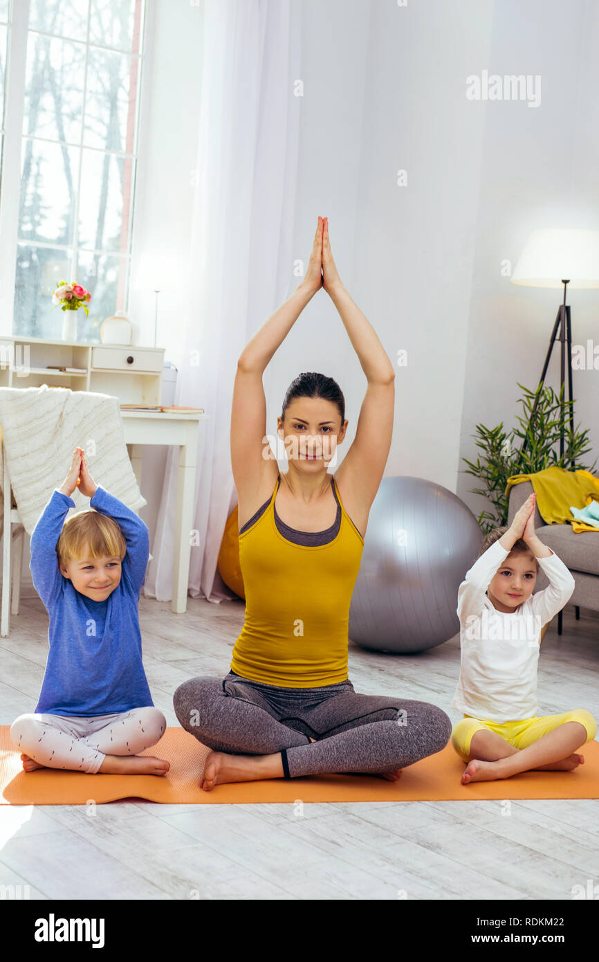 Cute positive kids putting their hands together Stock Photo - Alamy