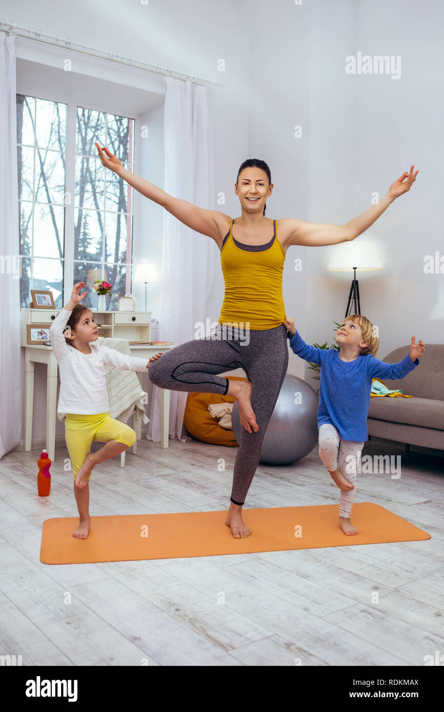 Joyful positive woman standing on one leg Stock Photo - Alamy