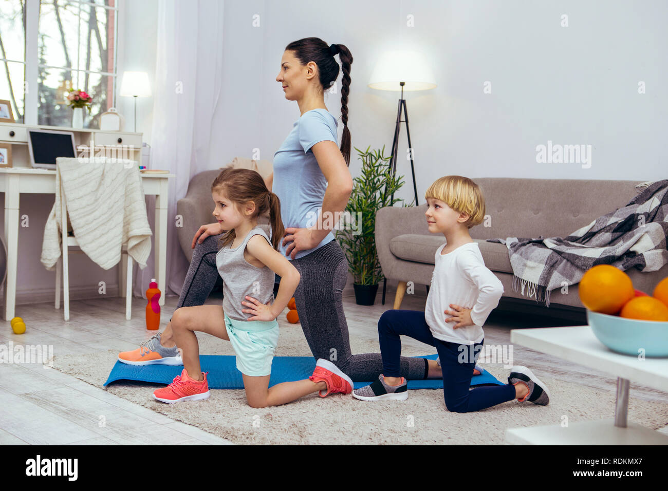 Positive nice active family doing sport together Stock Photo - Alamy