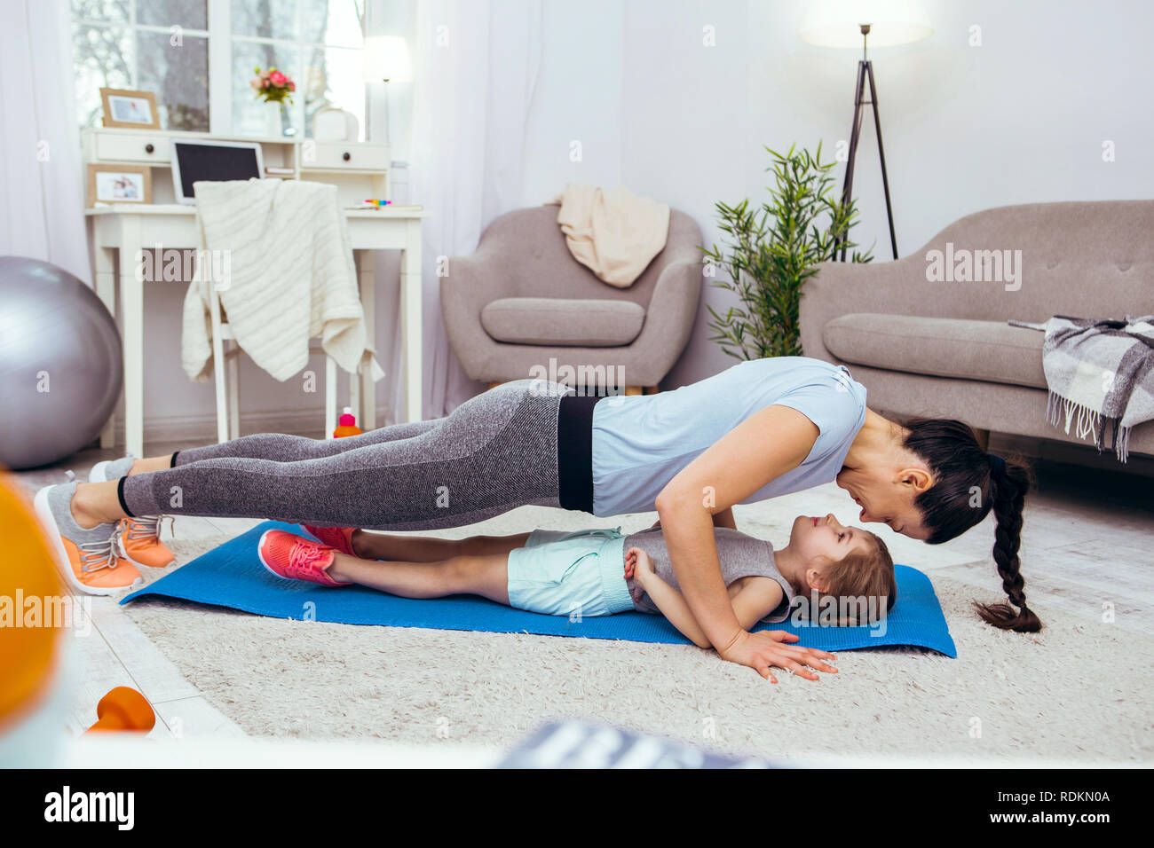 Positive cheerful woman smiling to her daughter Stock Photo - Alamy