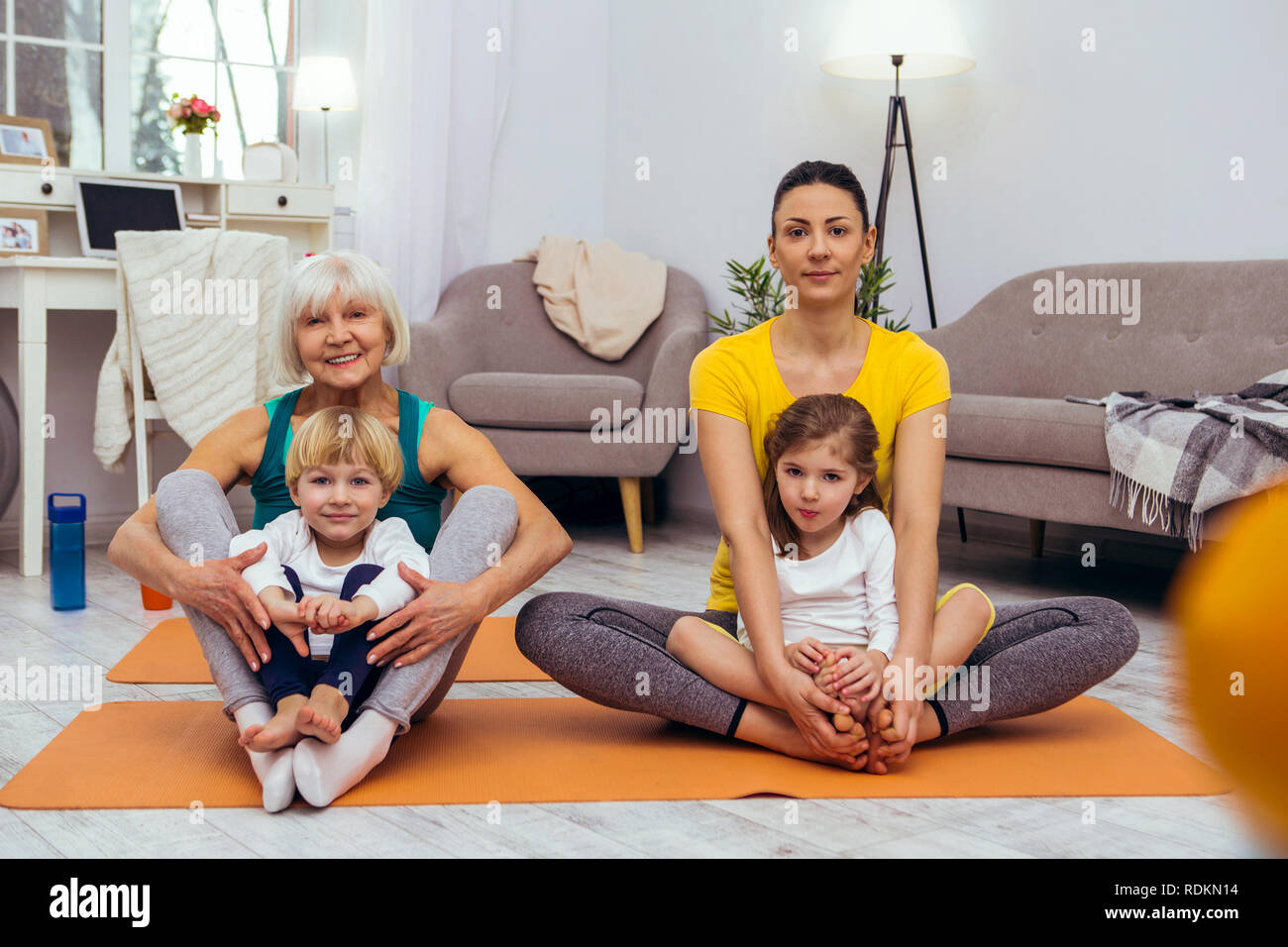 Joyful positive nice family doing sport together Stock Photo - Alamy