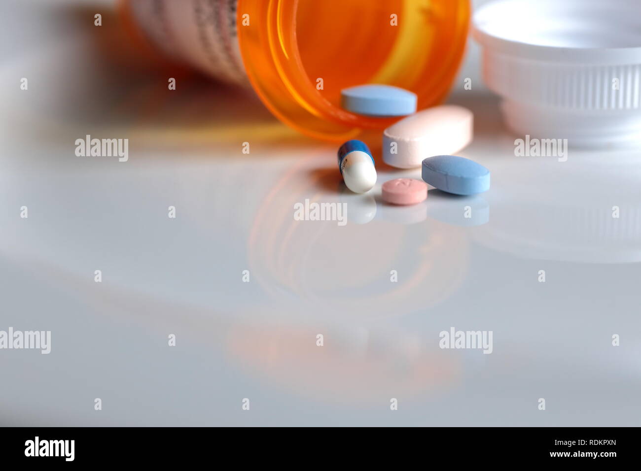 Medicine pills bottle spill white background Stock Photo - Alamy