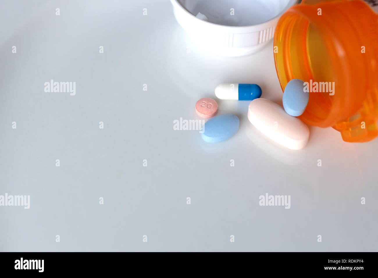 Medicine pills bottle spill white background Stock Photo - Alamy