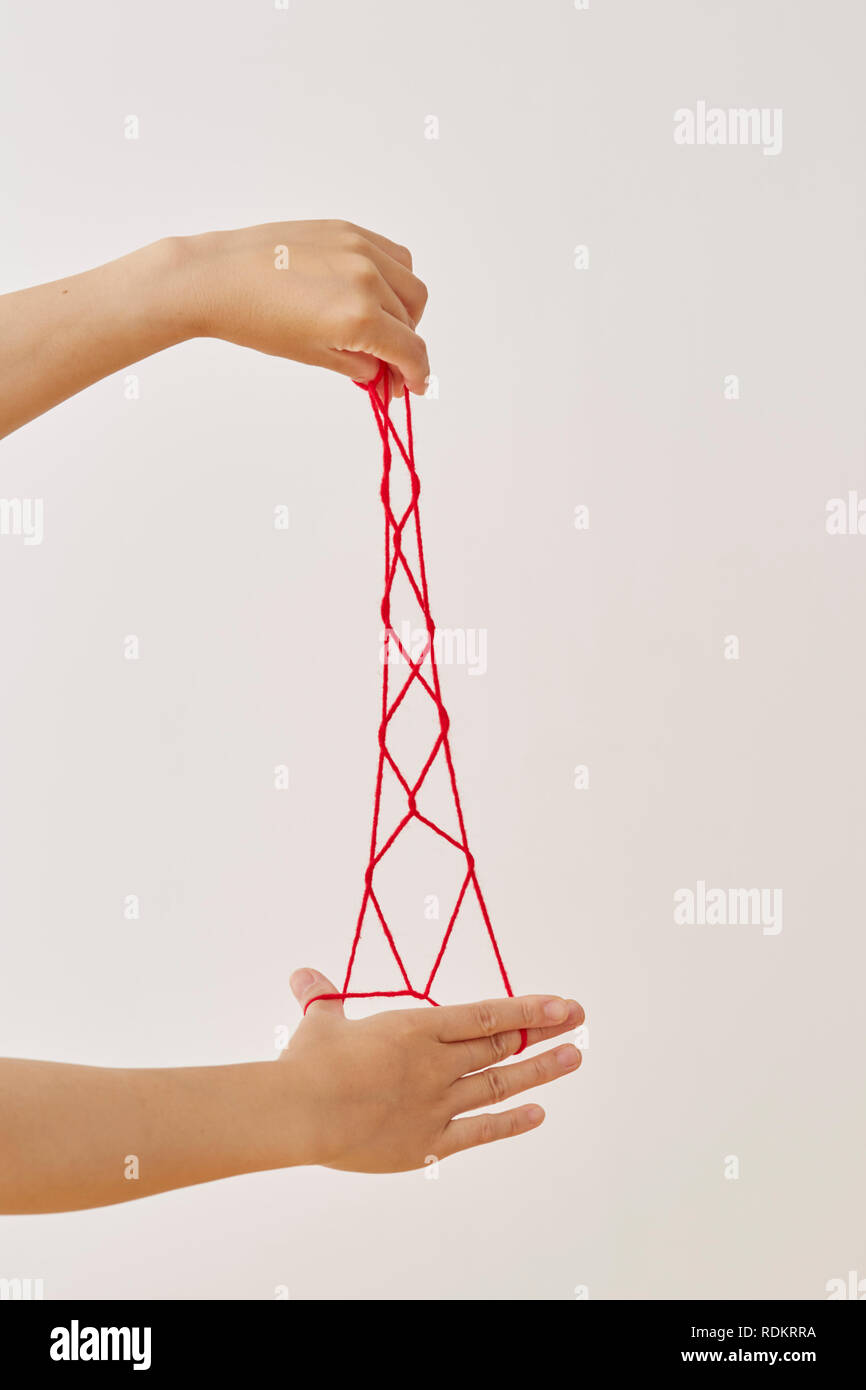 Japanese woman playing with red string Stock Photo - Alamy