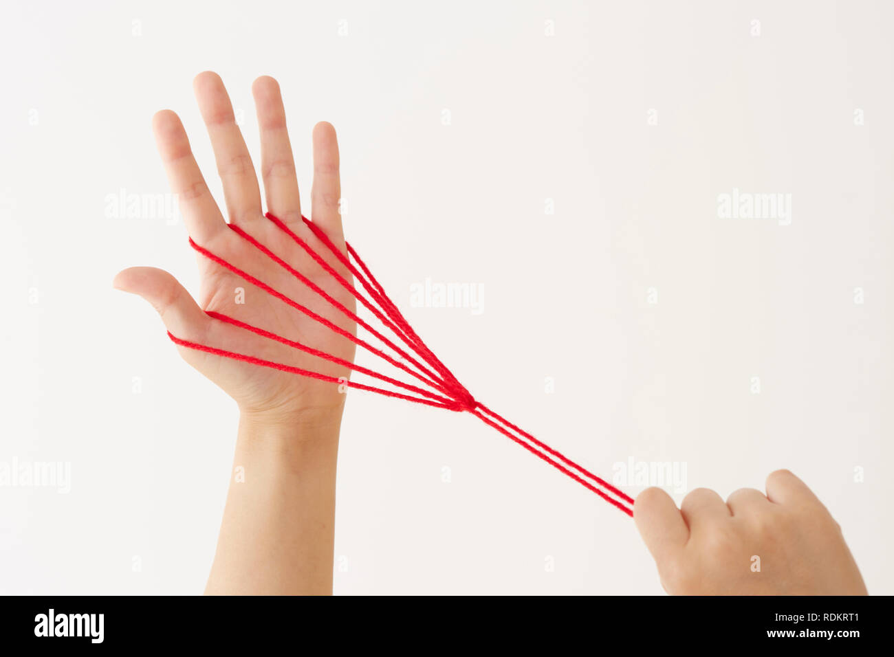 Japanese woman playing with red string Stock Photo - Alamy
