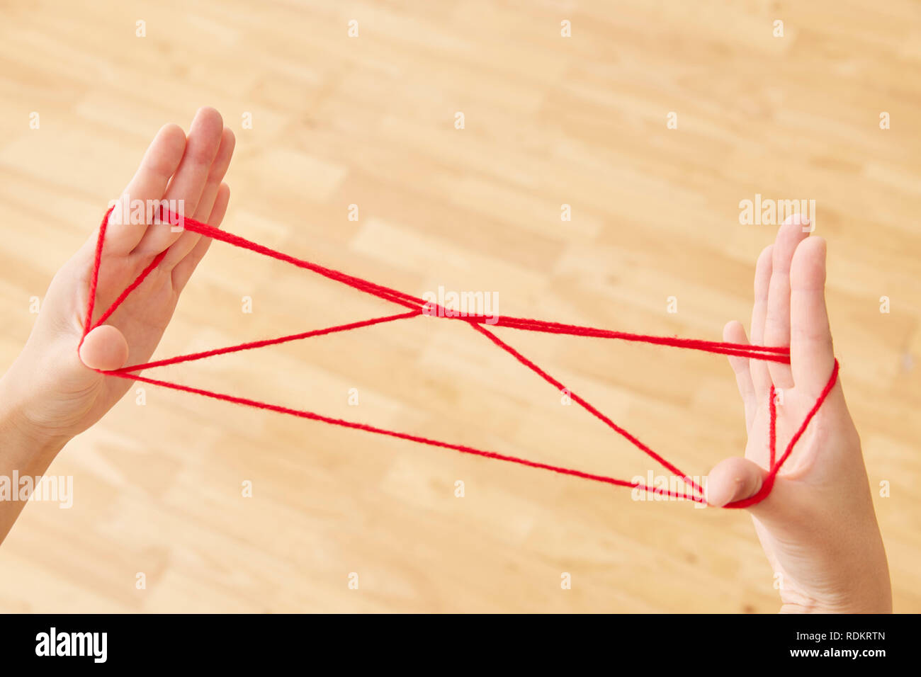 Japanese woman playing with red string Stock Photo - Alamy