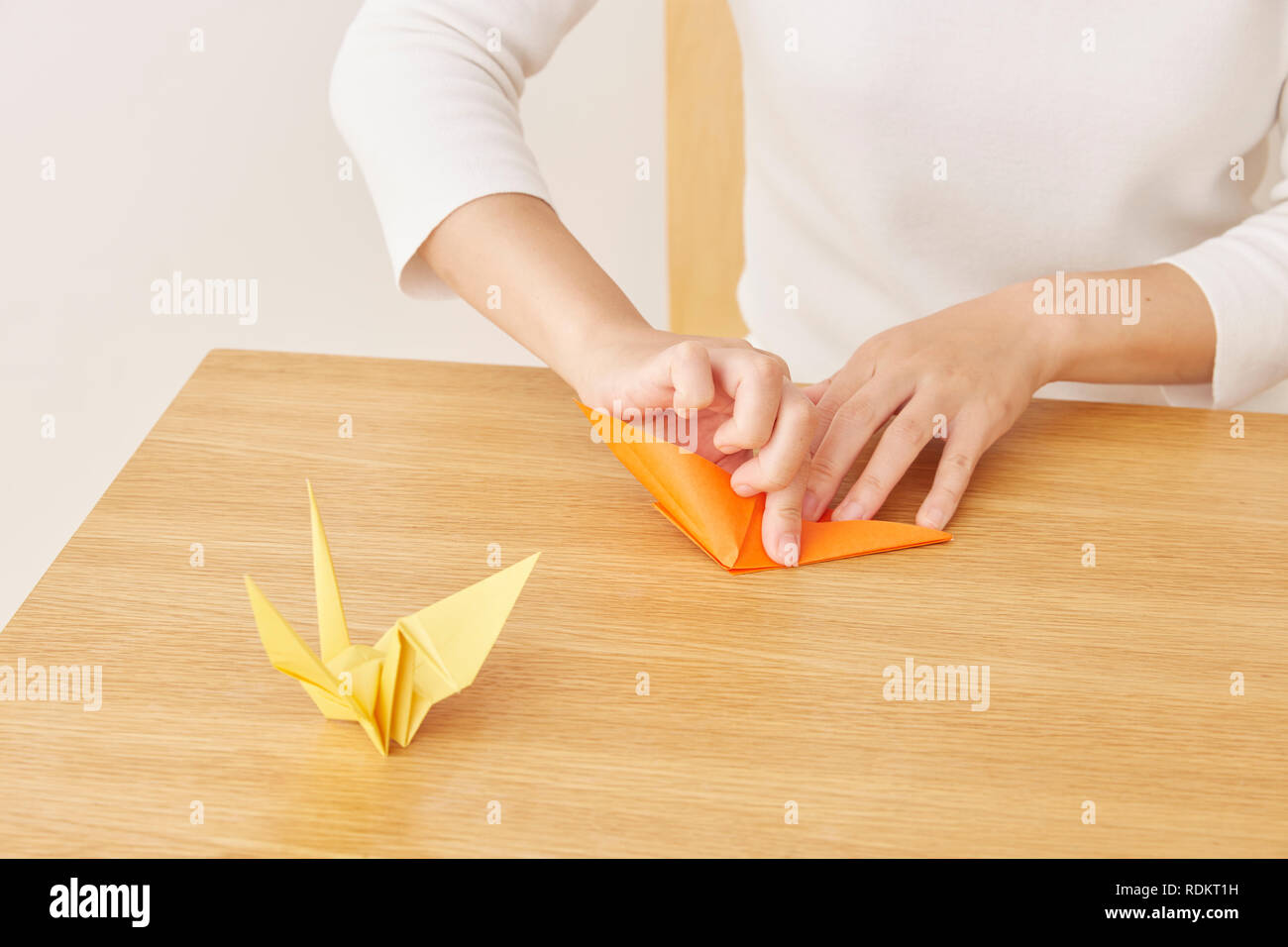 Woman folding paper origami hi-res stock photography and images - Alamy