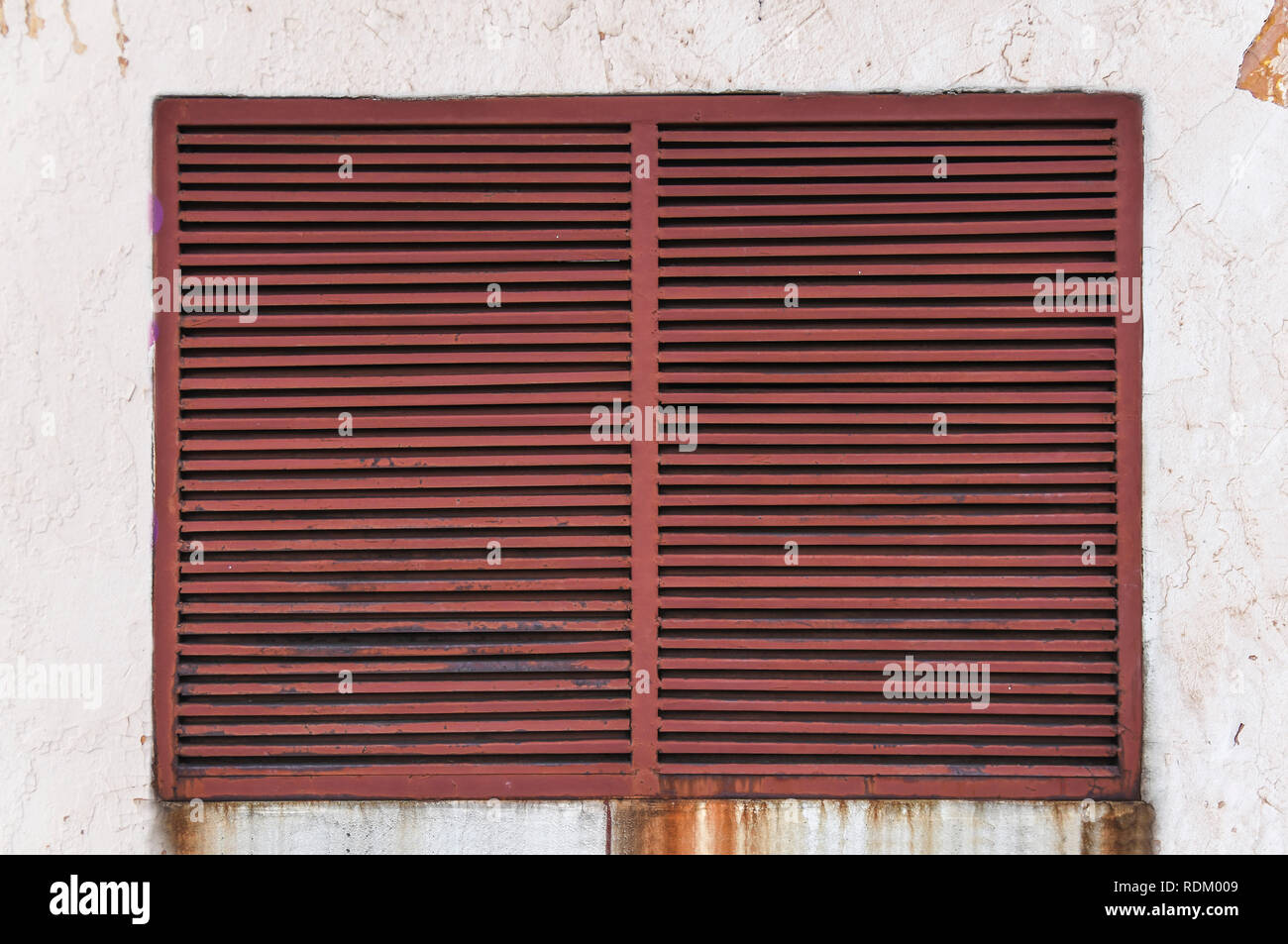 Iron brown closed window on white texture facade with rough structure ...