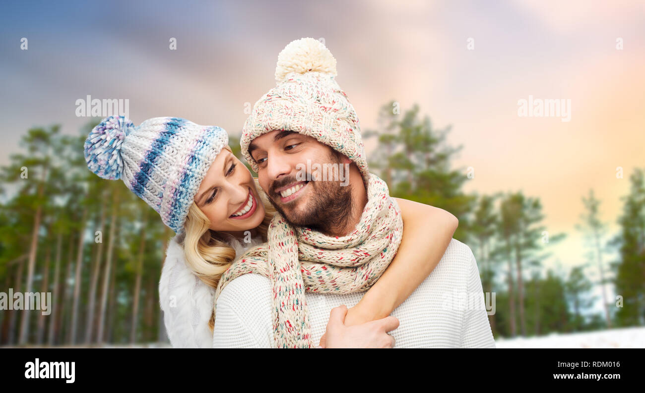 couple hugging over winter forest background Stock Photo - Alamy