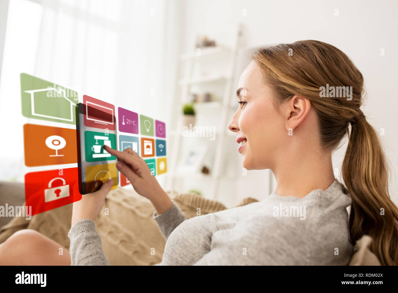 woman with tablet computer and smart home icons Stock Photo - Alamy