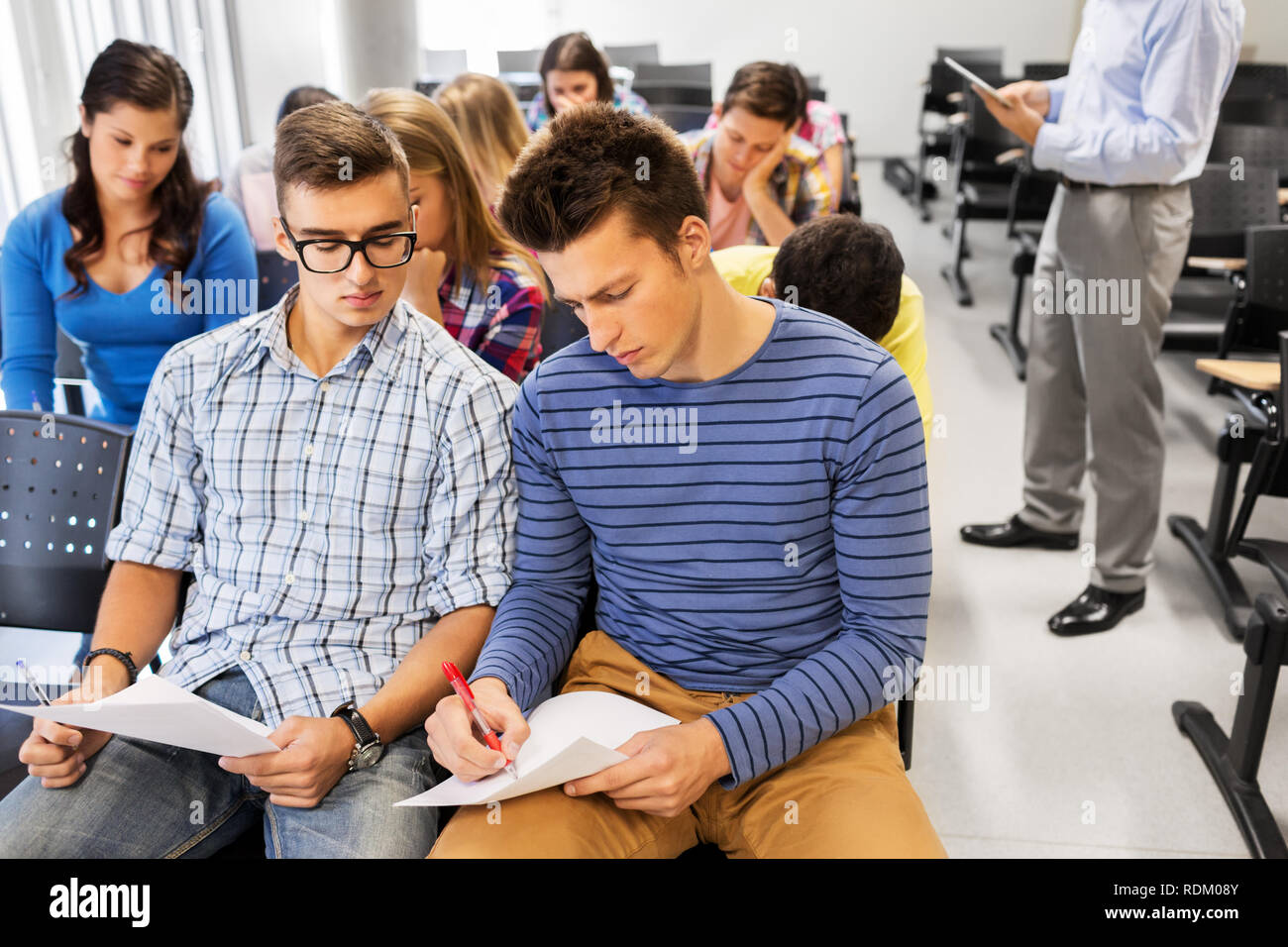 group of students with papers in lecture hall Stock Photo - Alamy