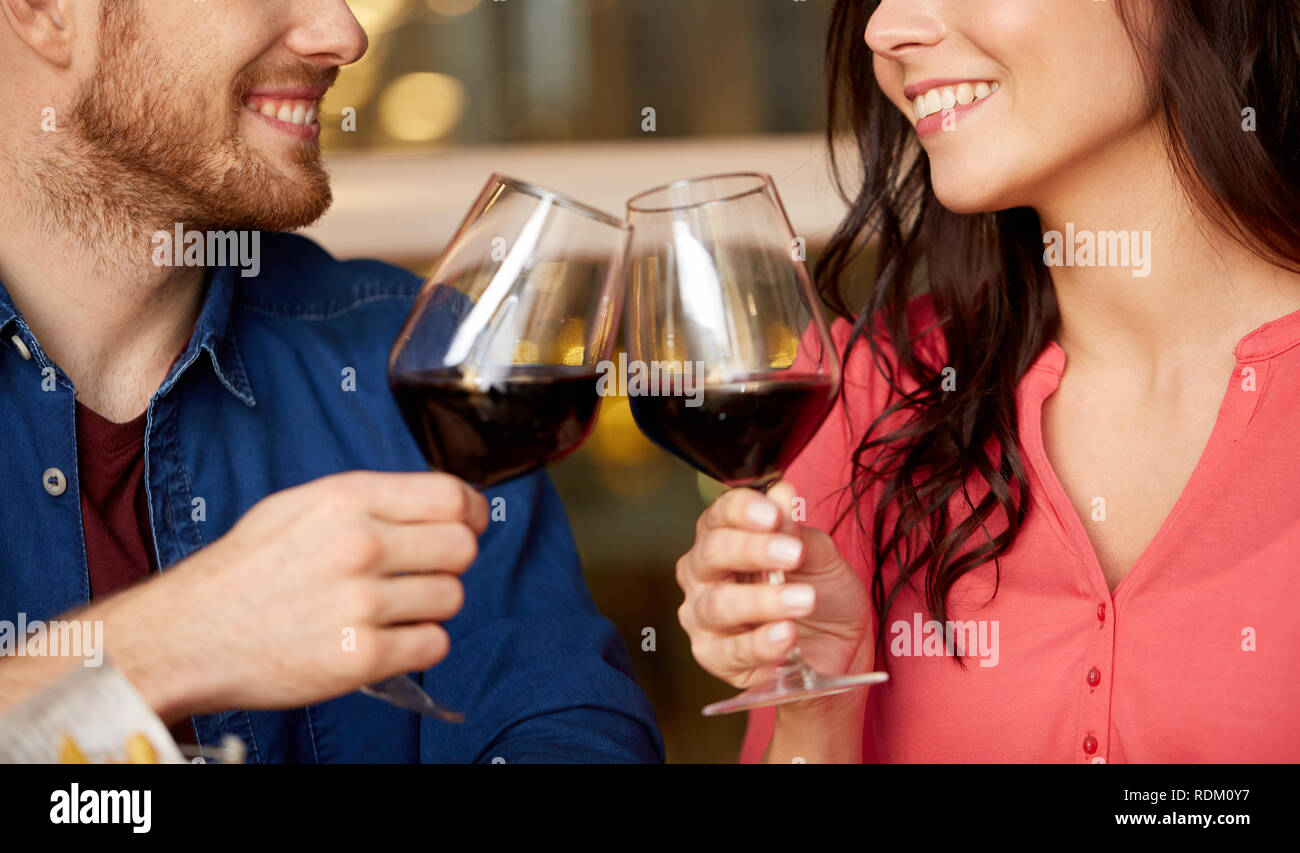 happy couple drinking red wine at restaurant Stock Photo - Alamy