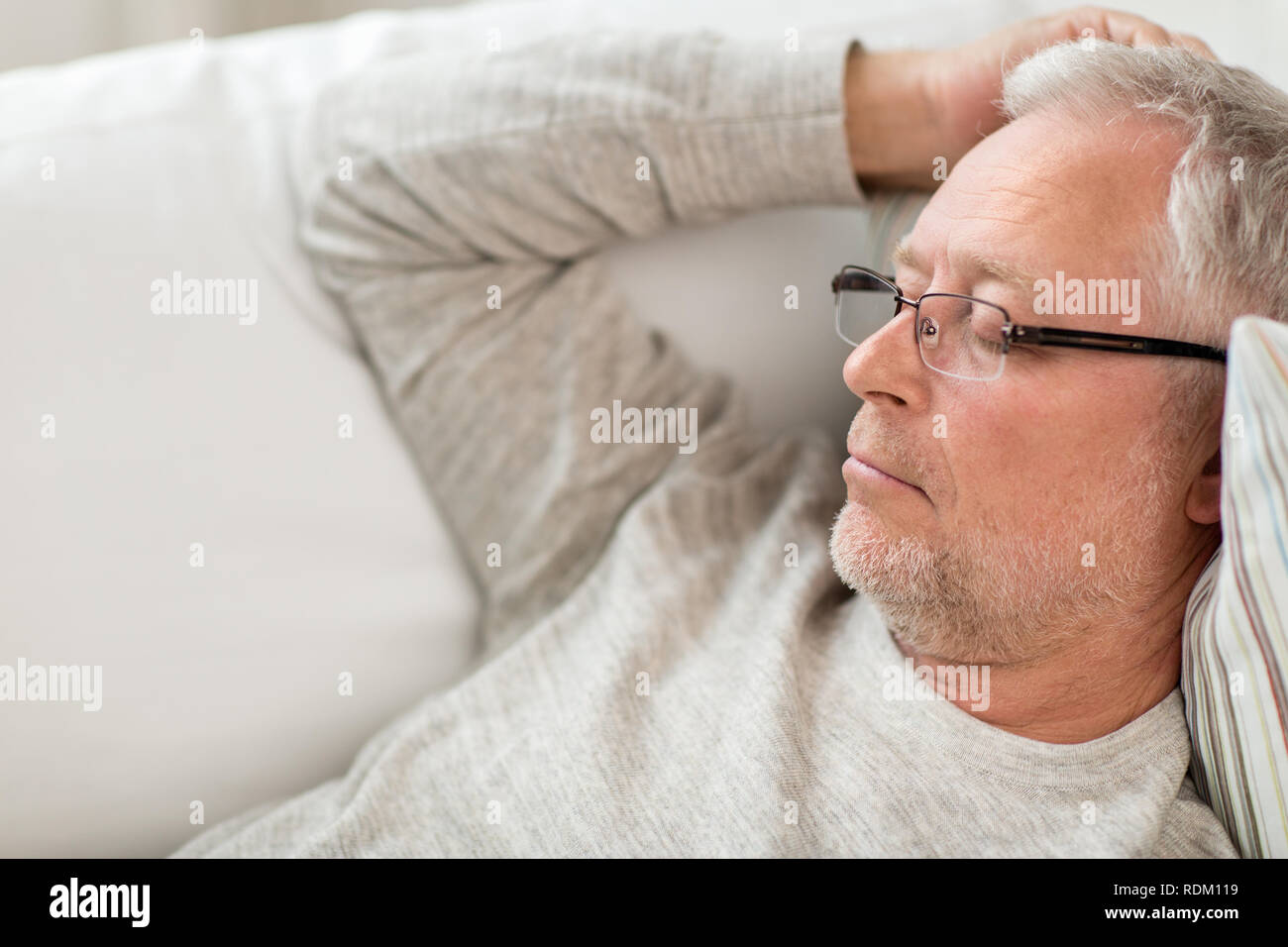 senior man sleeping on sofa at home Stock Photo - Alamy