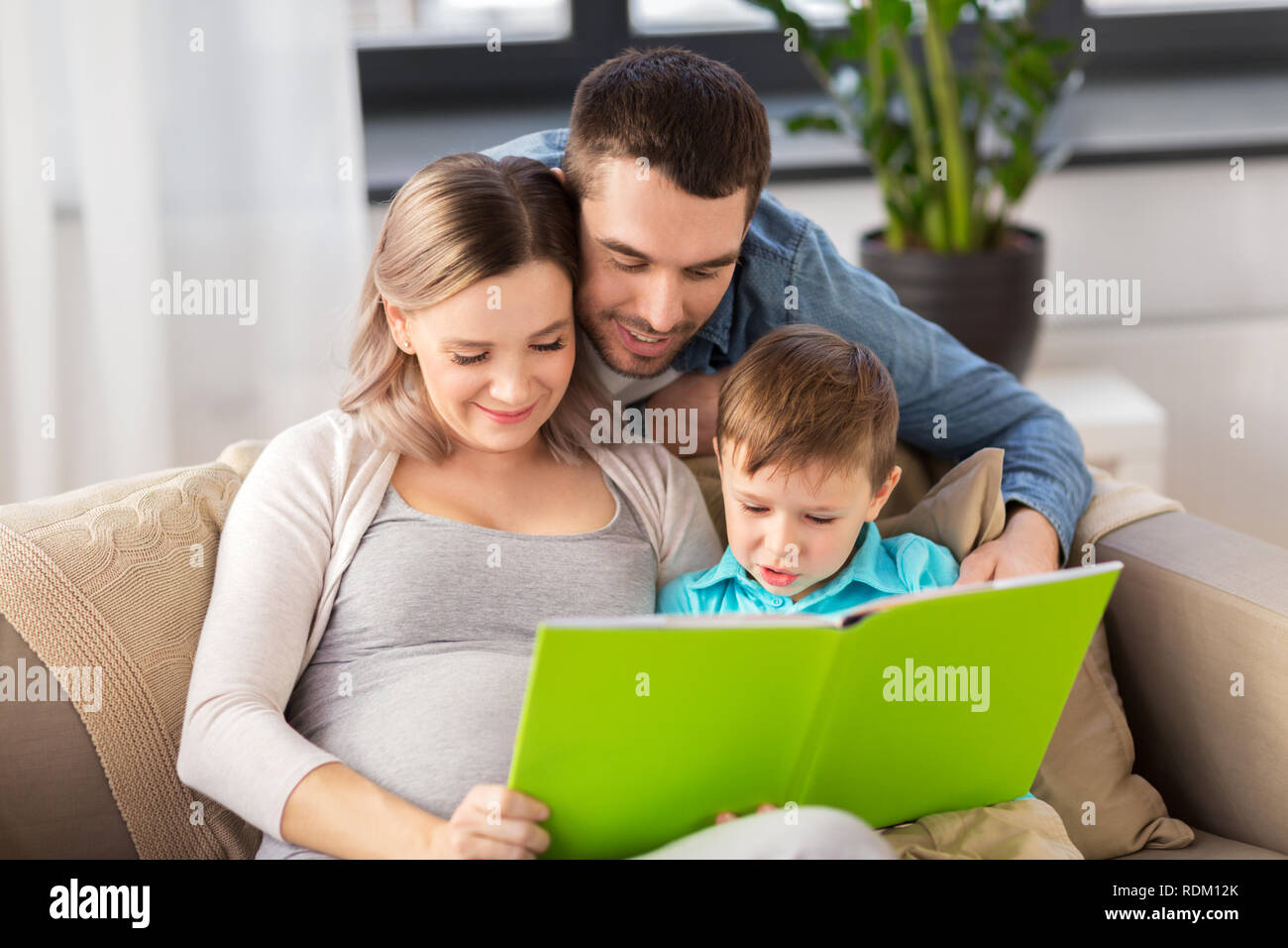 happy family reading book at home Stock Photo - Alamy