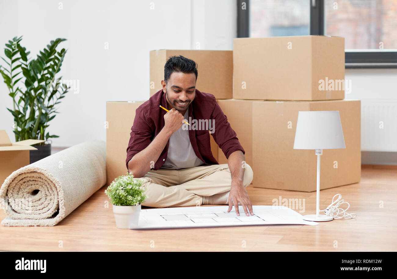 man with boxes and blueprint moving to new home Stock Photo - Alamy