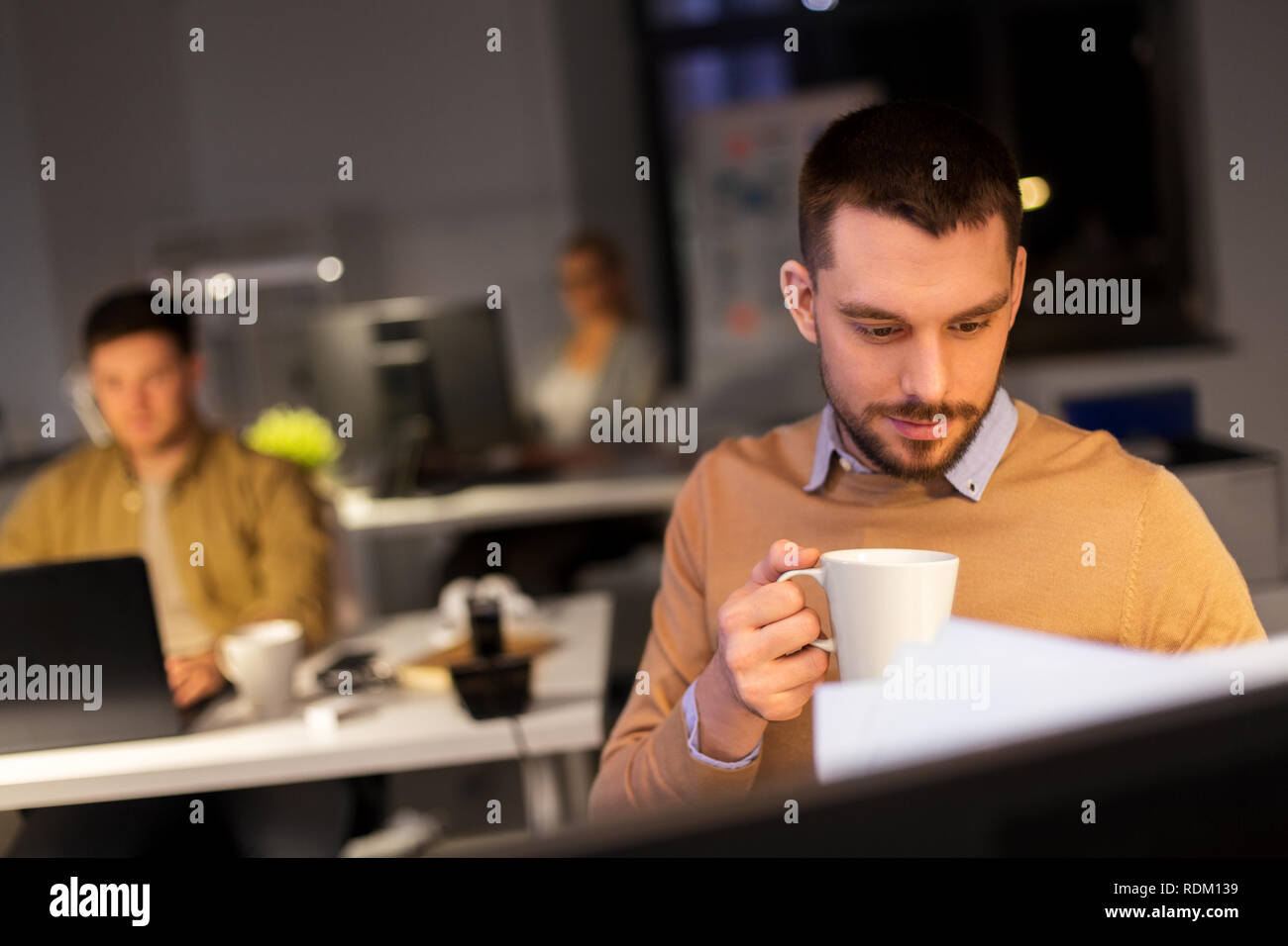 happy male office worker drinking coffee Stock Photo - Alamy