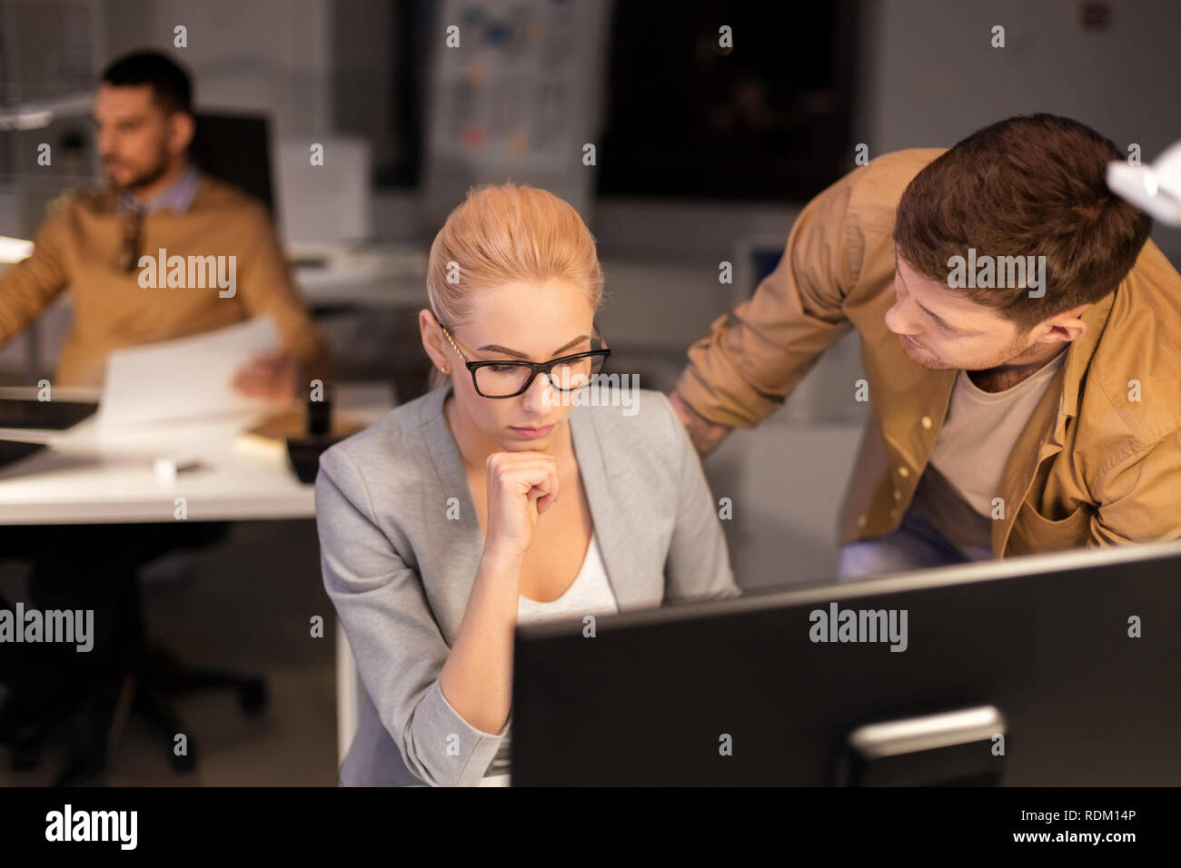 business team with computer working late at office Stock Photo - Alamy