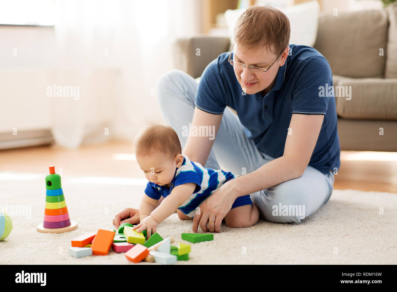 happy father with baby son playing toys at home Stock Photo - Alamy