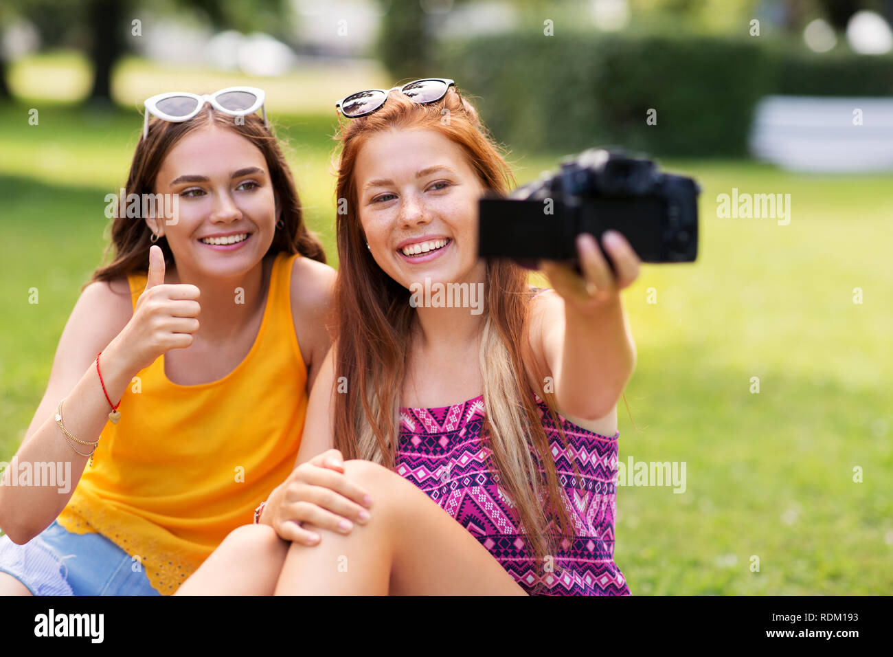 teenage bloggers recording video by camera in park Stock Photo - Alamy