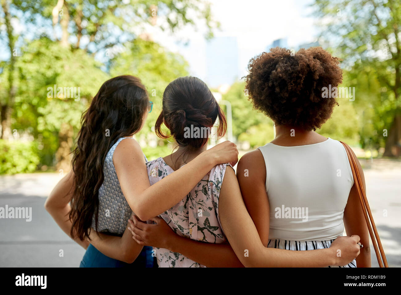 Back view three women hugging hi-res stock photography and images - Alamy