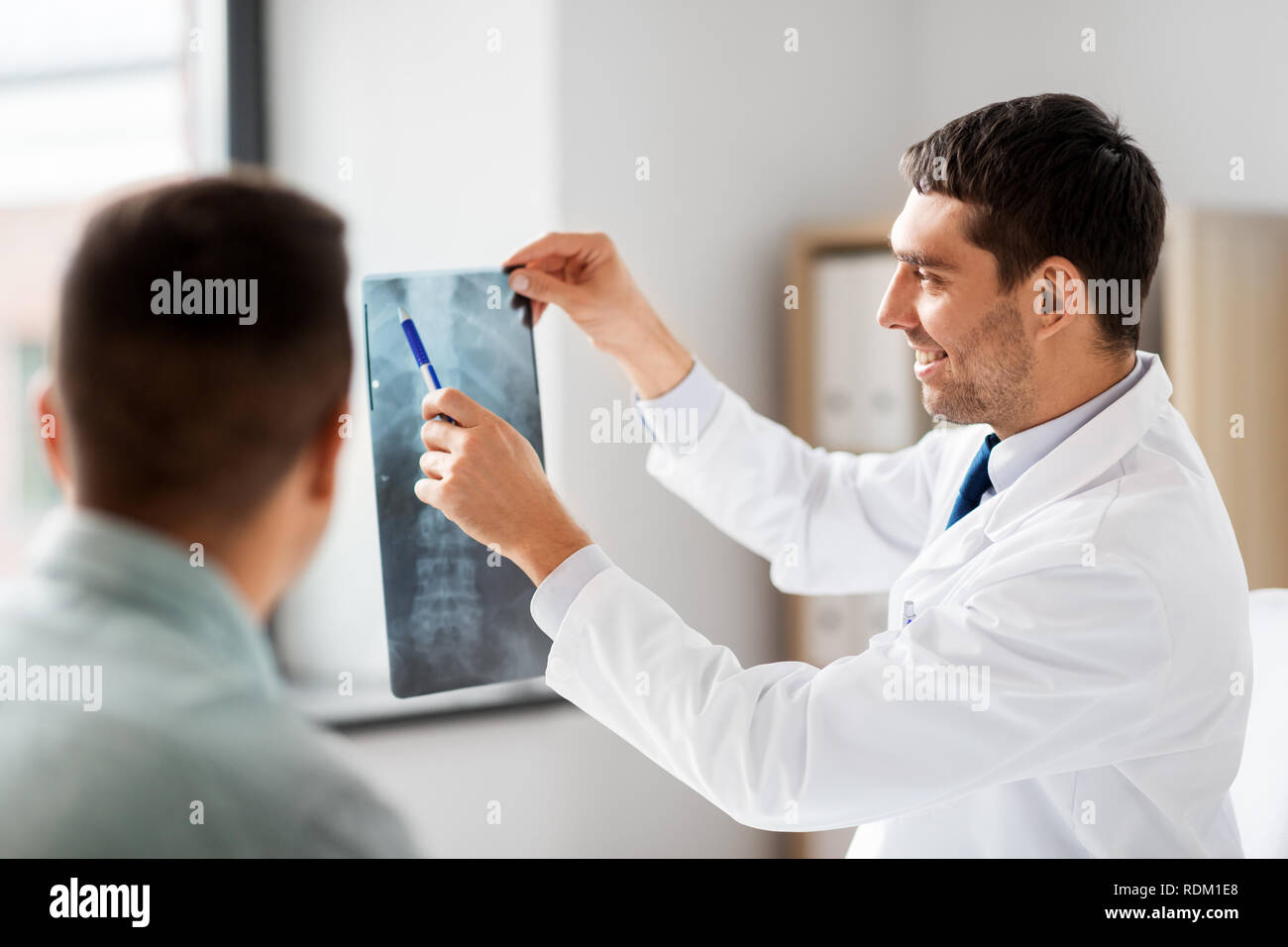 doctor showing x-ray to patient at hospital Stock Photo - Alamy