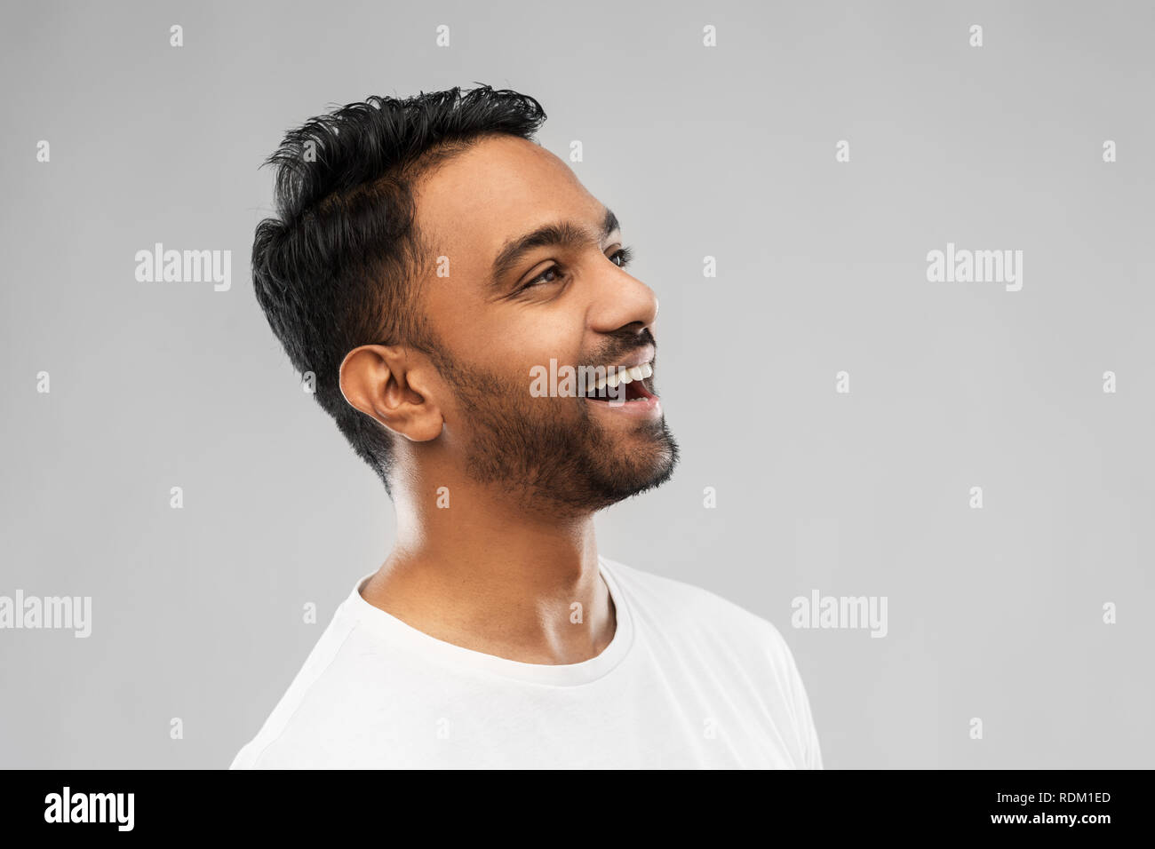 young laughing indian man over gray background Stock Photo - Alamy