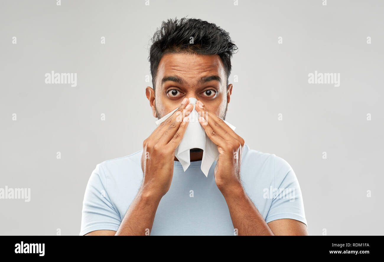 indian man with paper napkin blowing nose Stock Photo - Alamy