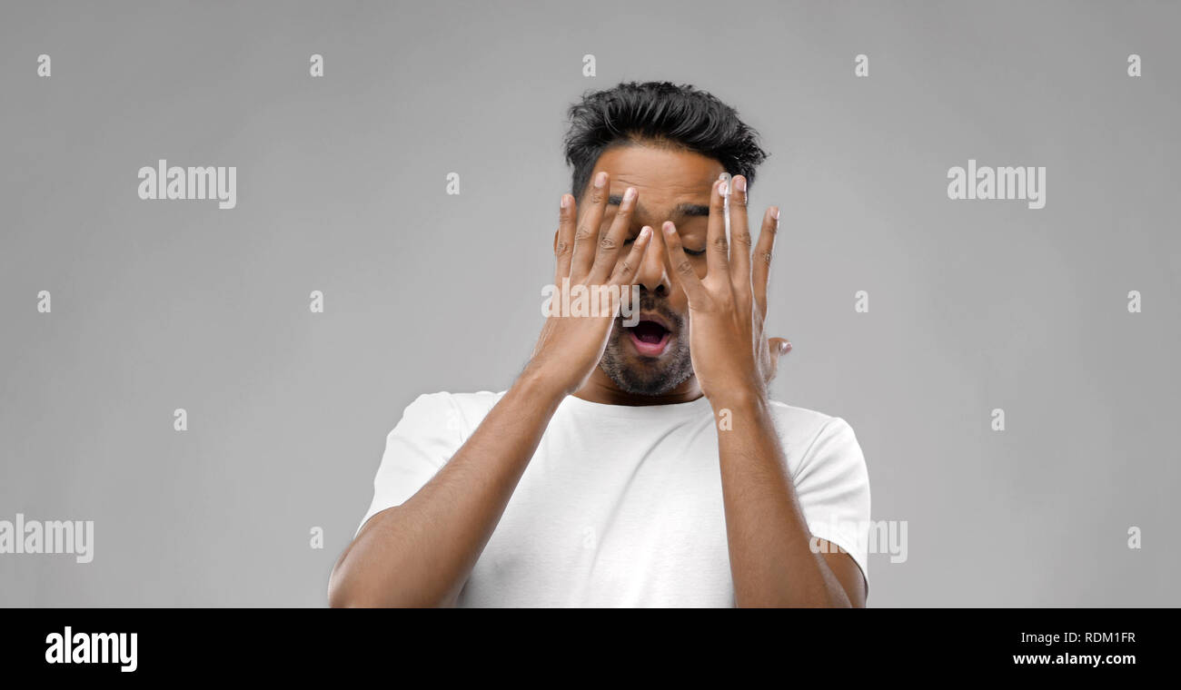 shocked indian man over grey background Stock Photo - Alamy