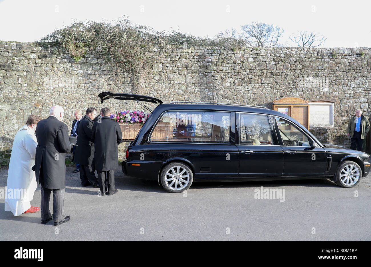 The coffin of June Whitfield is loaded into a hearse outside All ...