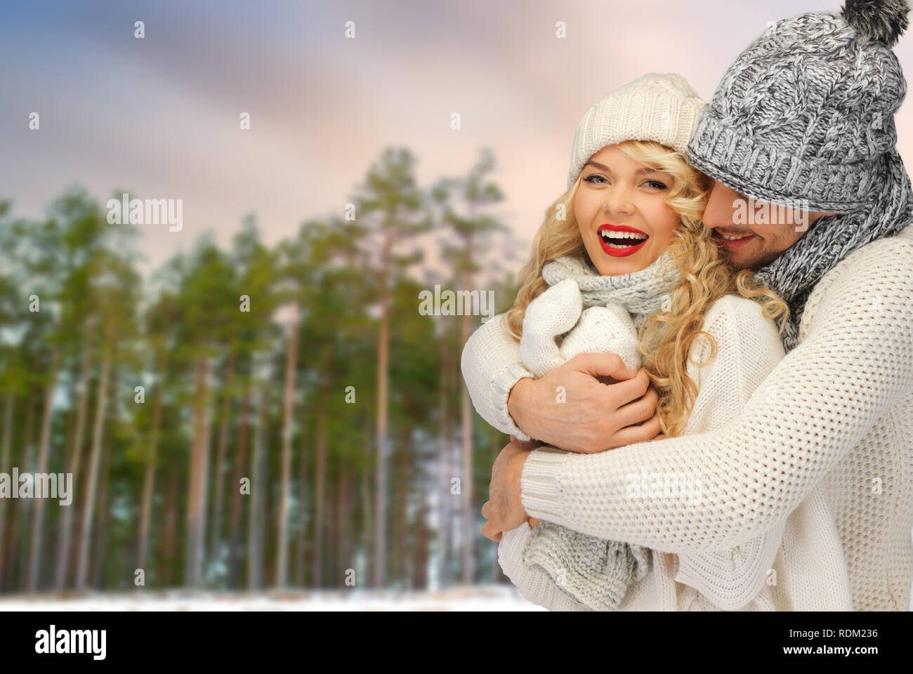 couple hugging over winter forest background Stock Photo - Alamy