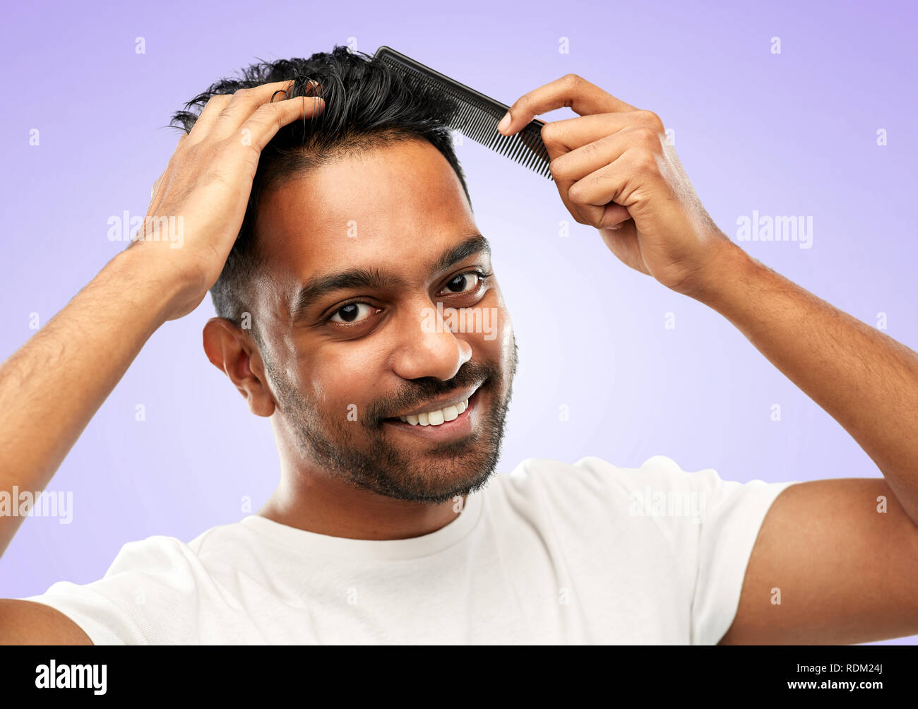happy indian man brushing hair with comb Stock Photo - Alamy