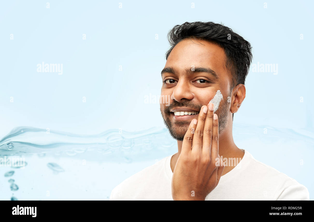 happy indian man applying cream to face Stock Photo - Alamy
