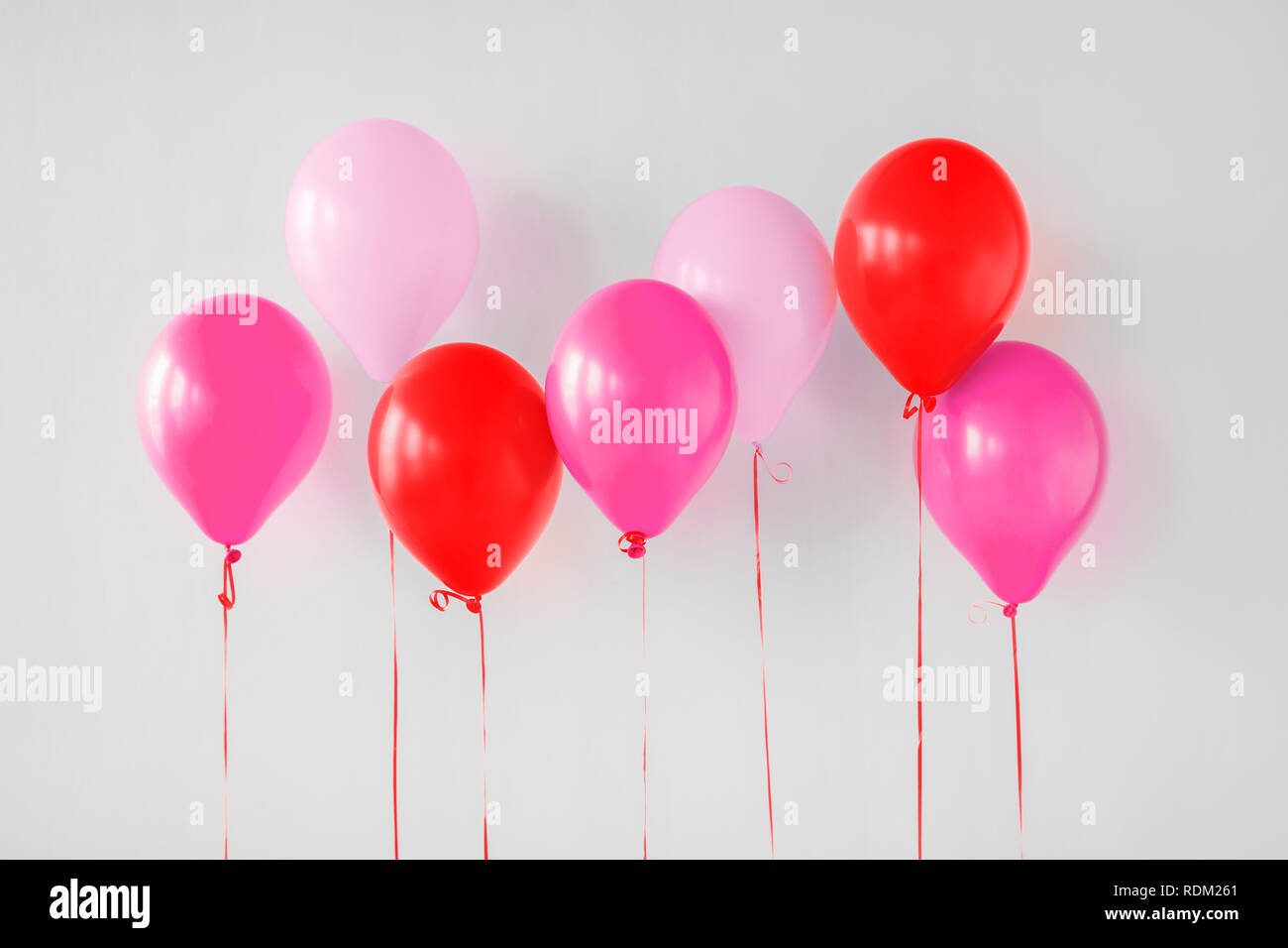 pink and red air balloons for birthday party Stock Photo - Alamy