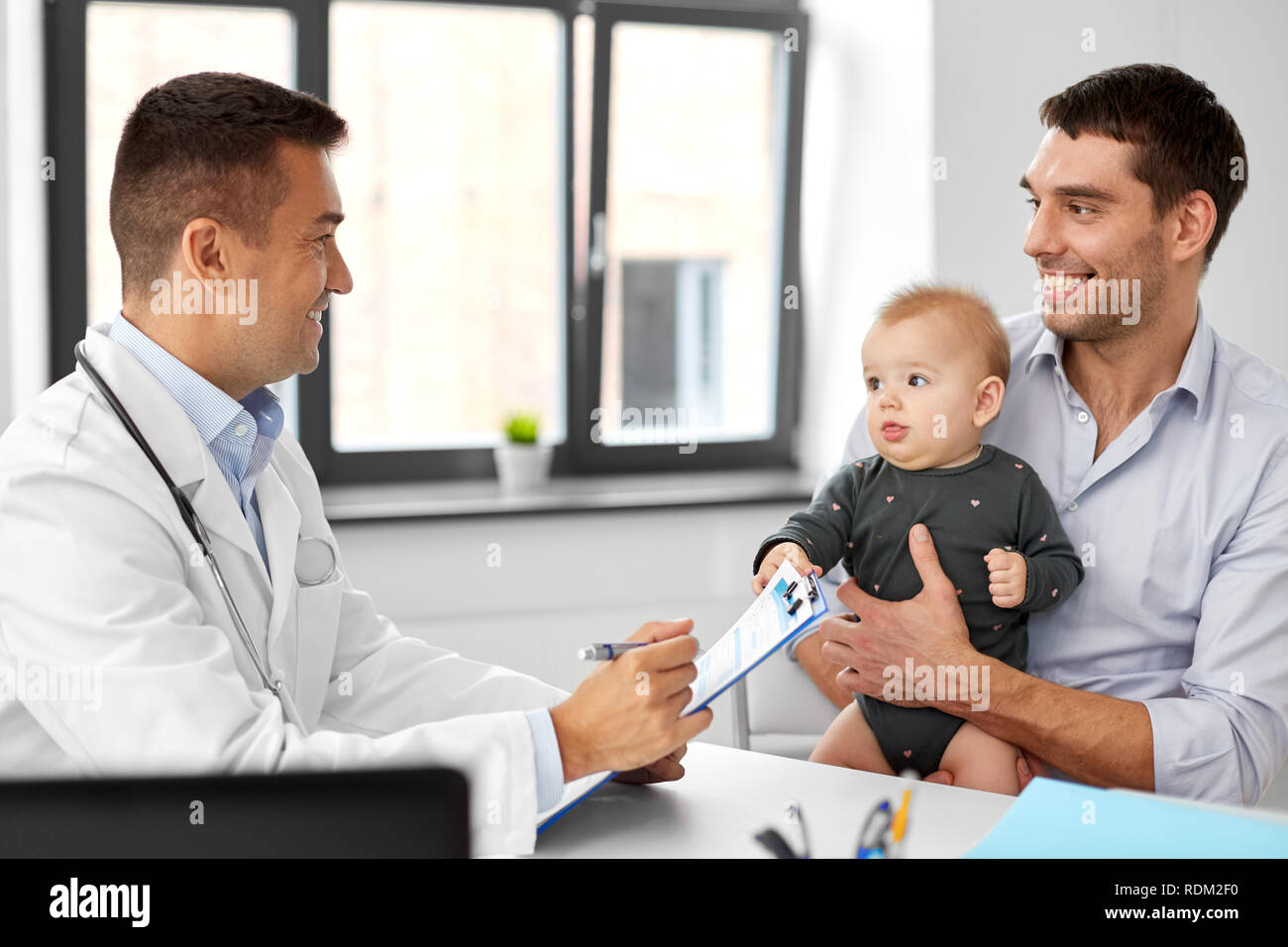 father with baby and doctor at clinic Stock Photo - Alamy