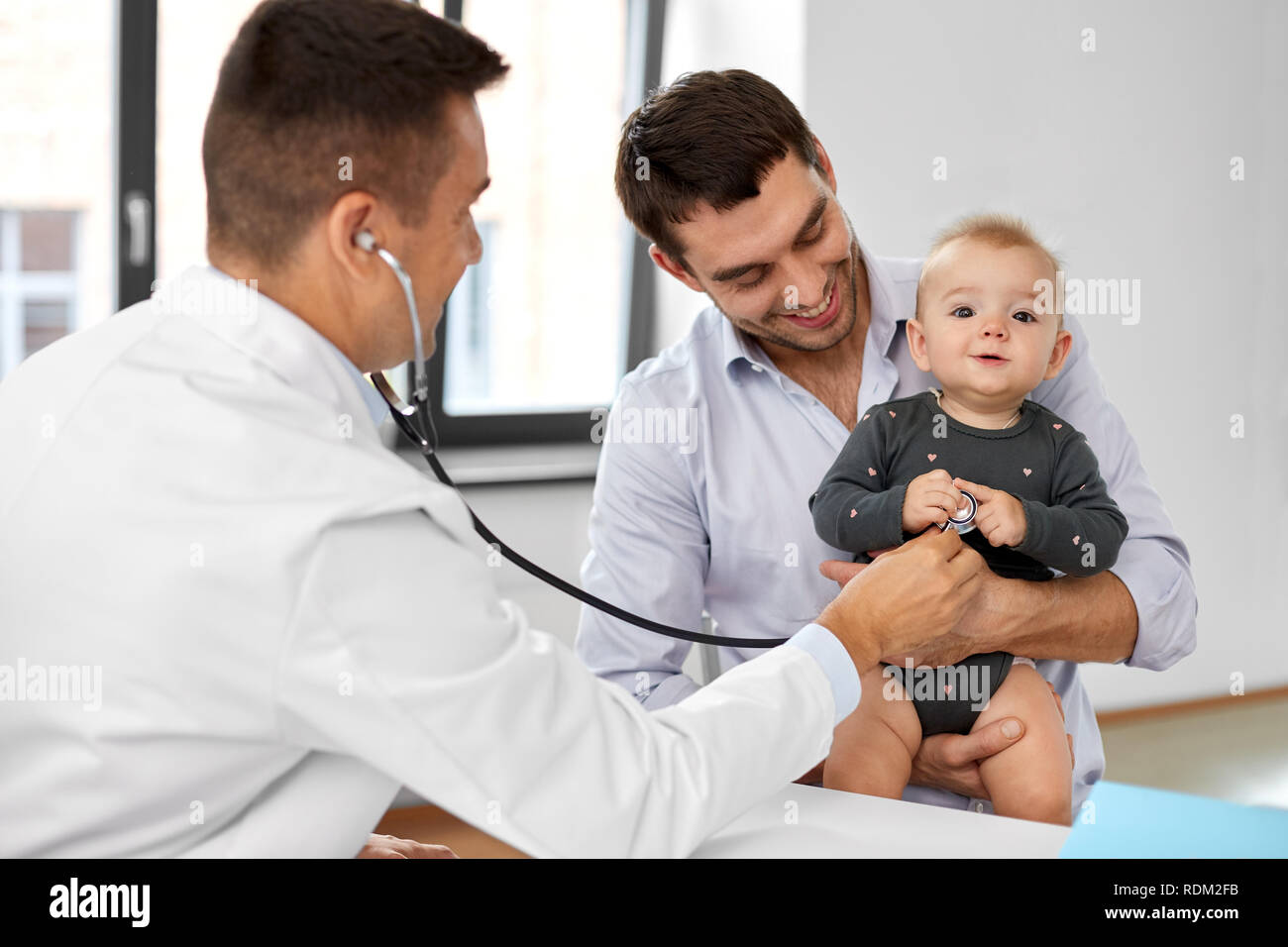 father with baby and doctor at clinic Stock Photo - Alamy