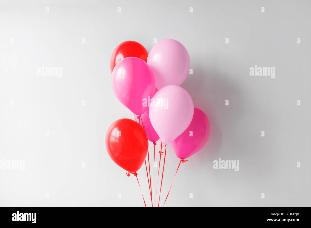pink and red air balloons for birthday party Stock Photo - Alamy