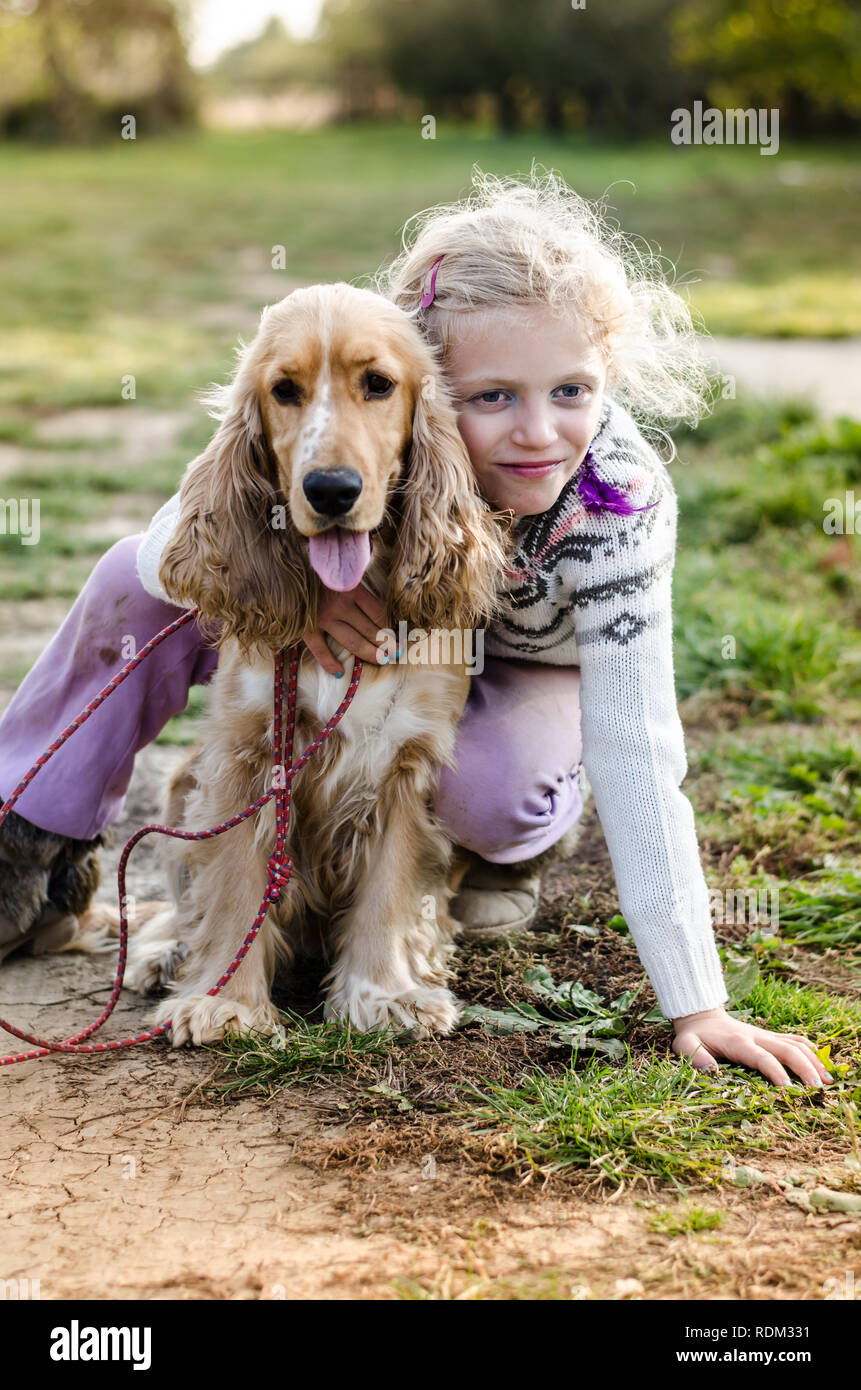 lovely blond girl with dog together outdoors Stock Photo - Alamy