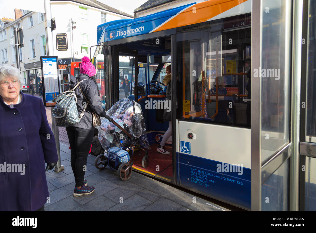A woman getting on a stagecoach bus with stroller, ashford town centre ...