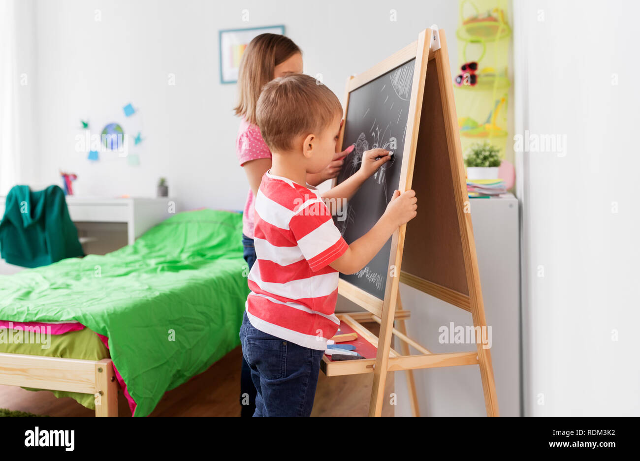 happy kids drawing on chalk board at home Stock Photo - Alamy