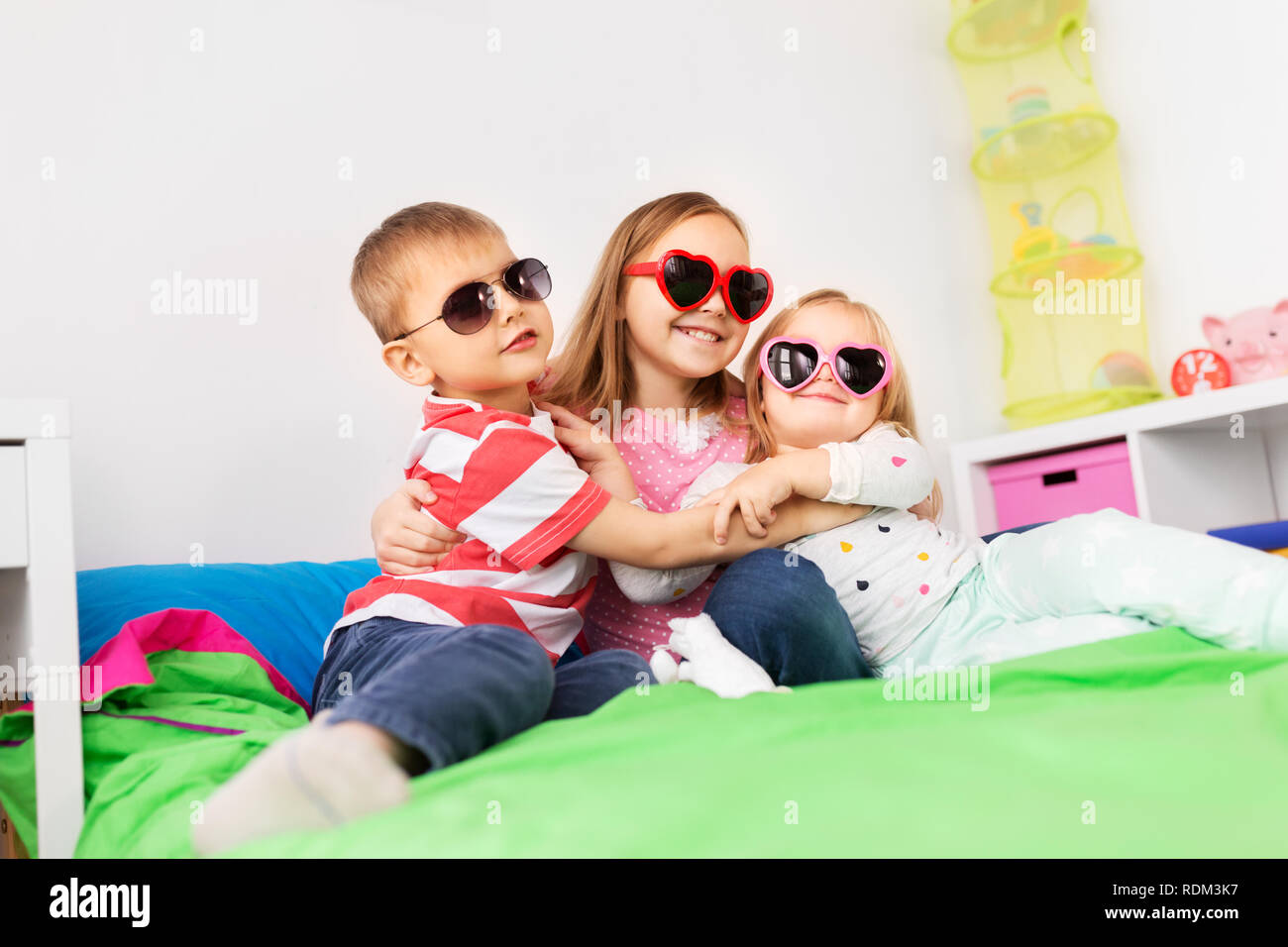 happy little kids in sunglasses hugging at home Stock Photo - Alamy