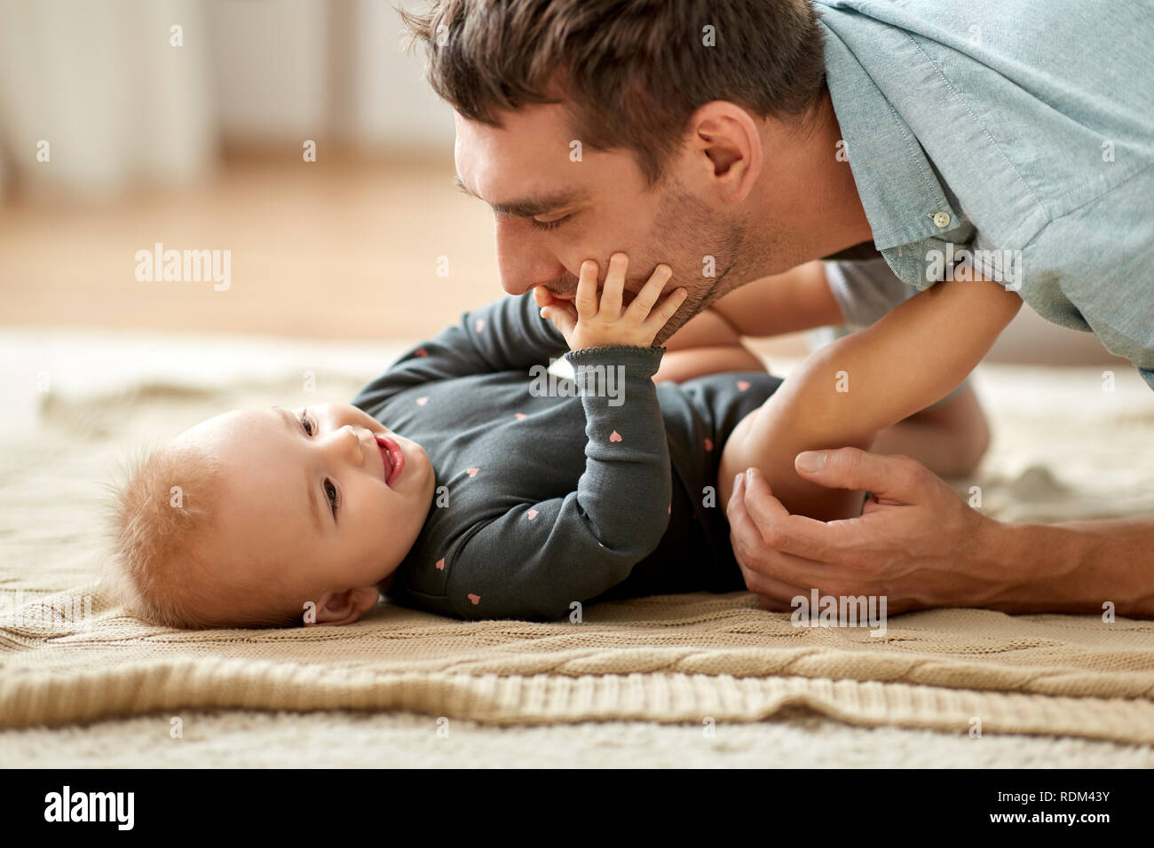 father playing with little baby daughter at home Stock Photo - Alamy