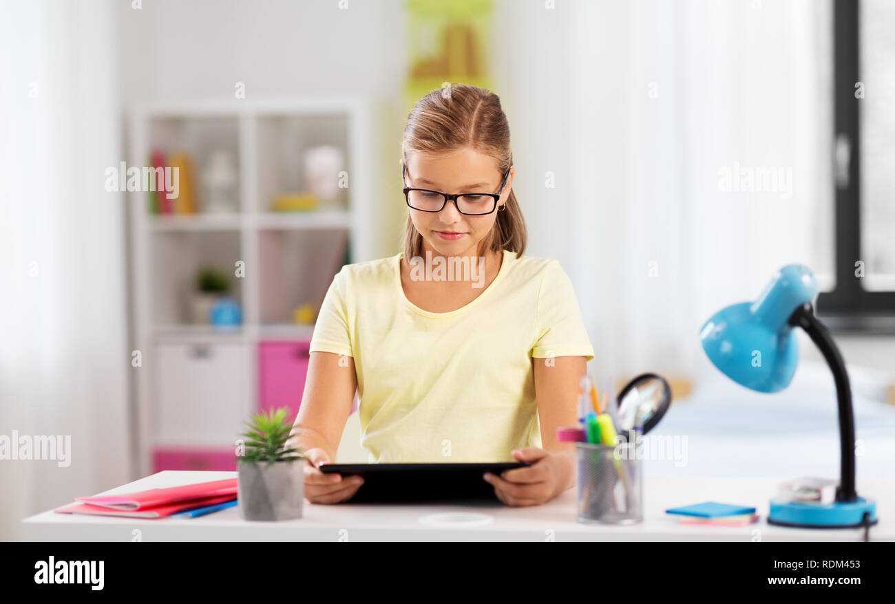 student girl with tablet computer doing homework Stock Photo - Alamy