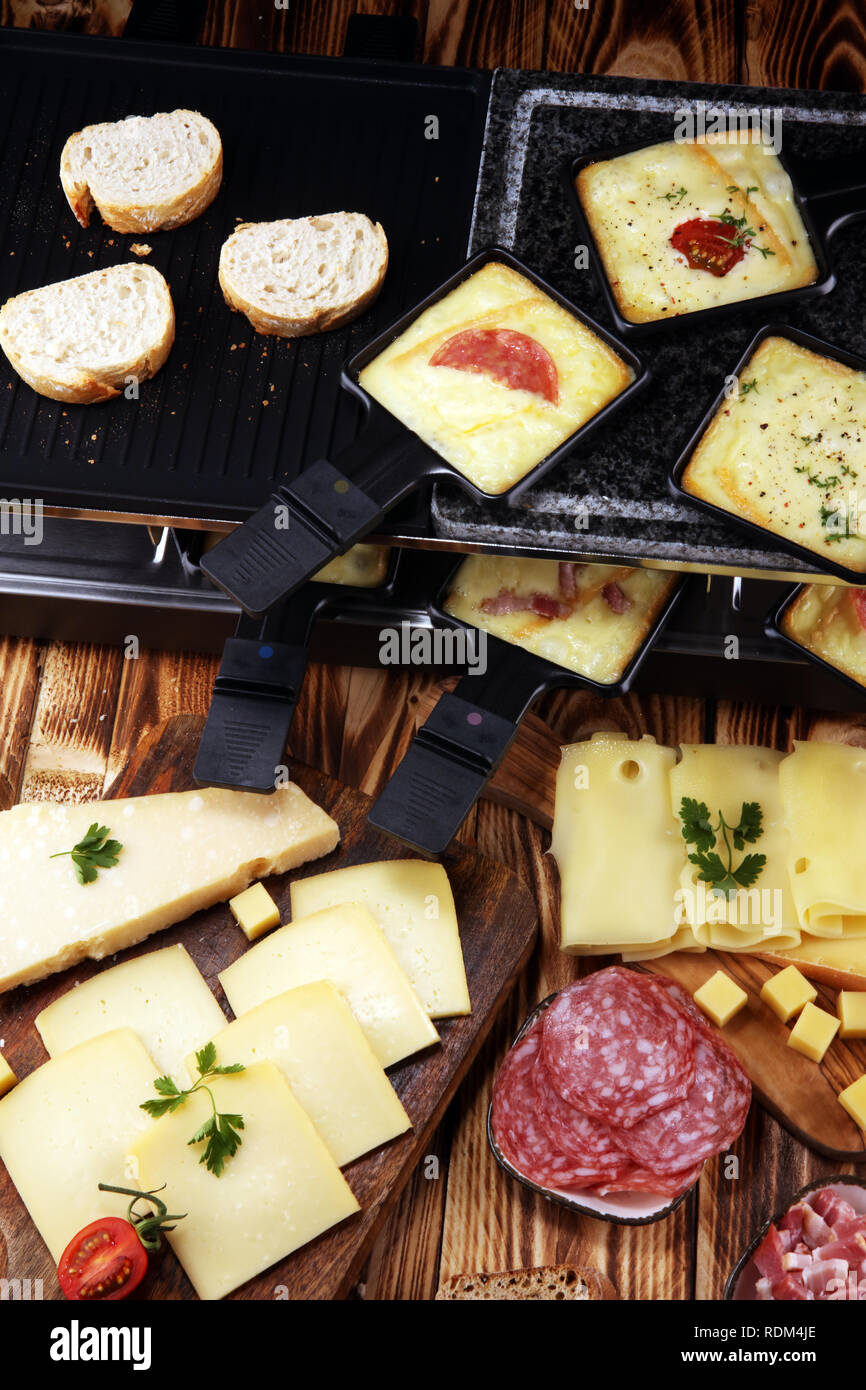 Delicious traditional Swiss melted raclette cheese served in individual ...