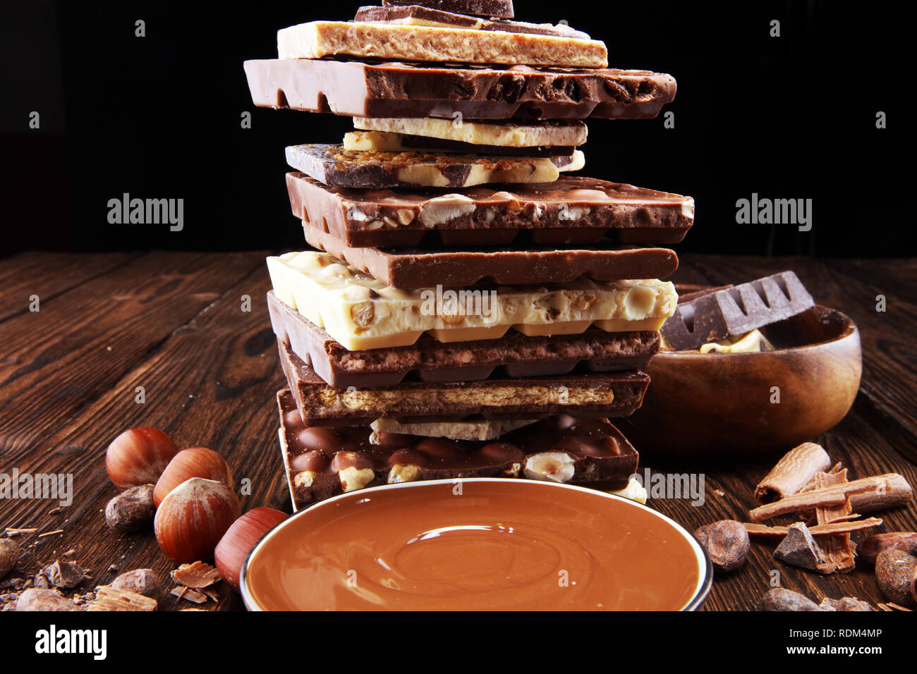 Chocolate bars on table with chocolate tower. Chocolate and nuts and ...
