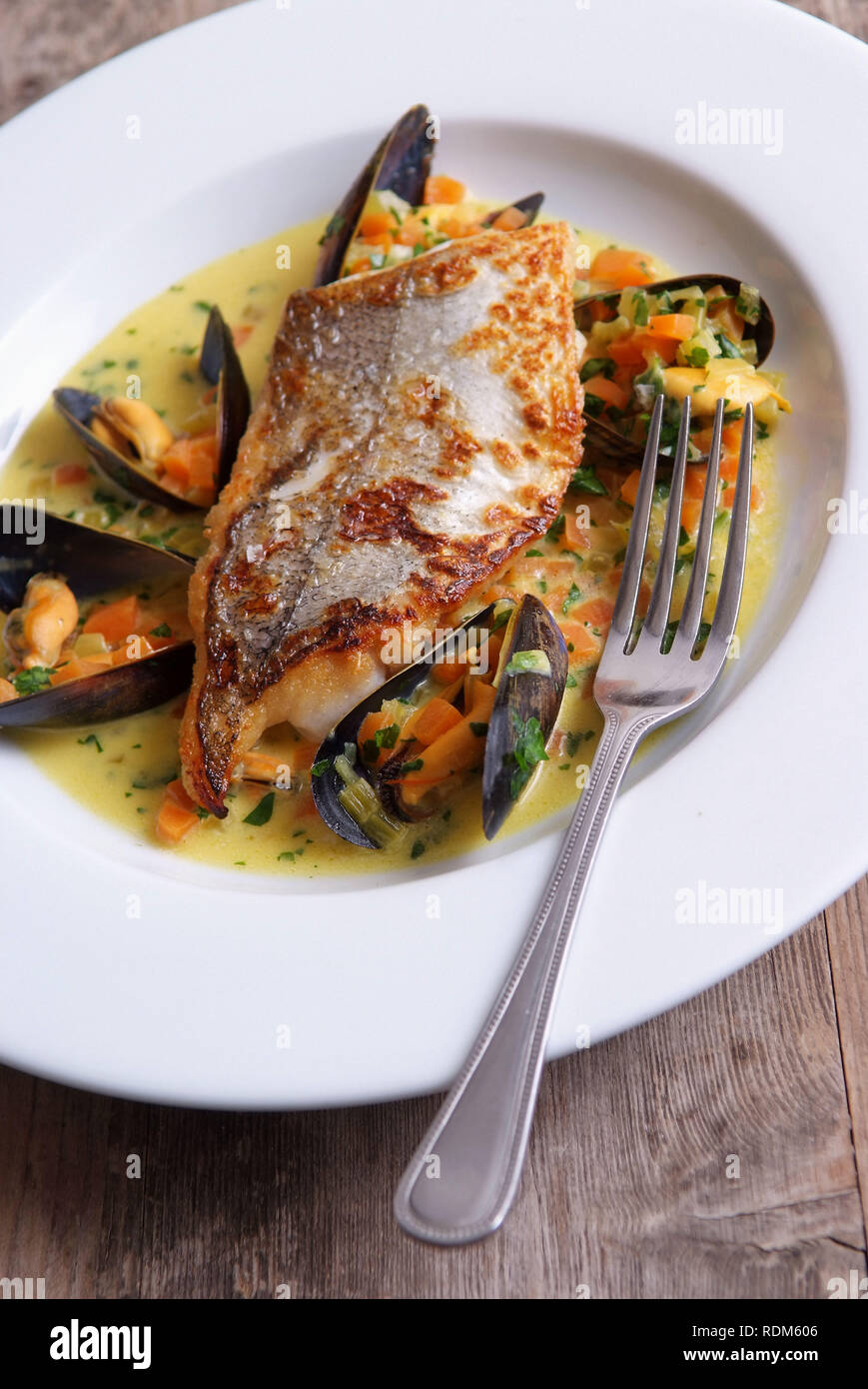 Hake fillet with mussels and saffron hi-res stock photography and ...