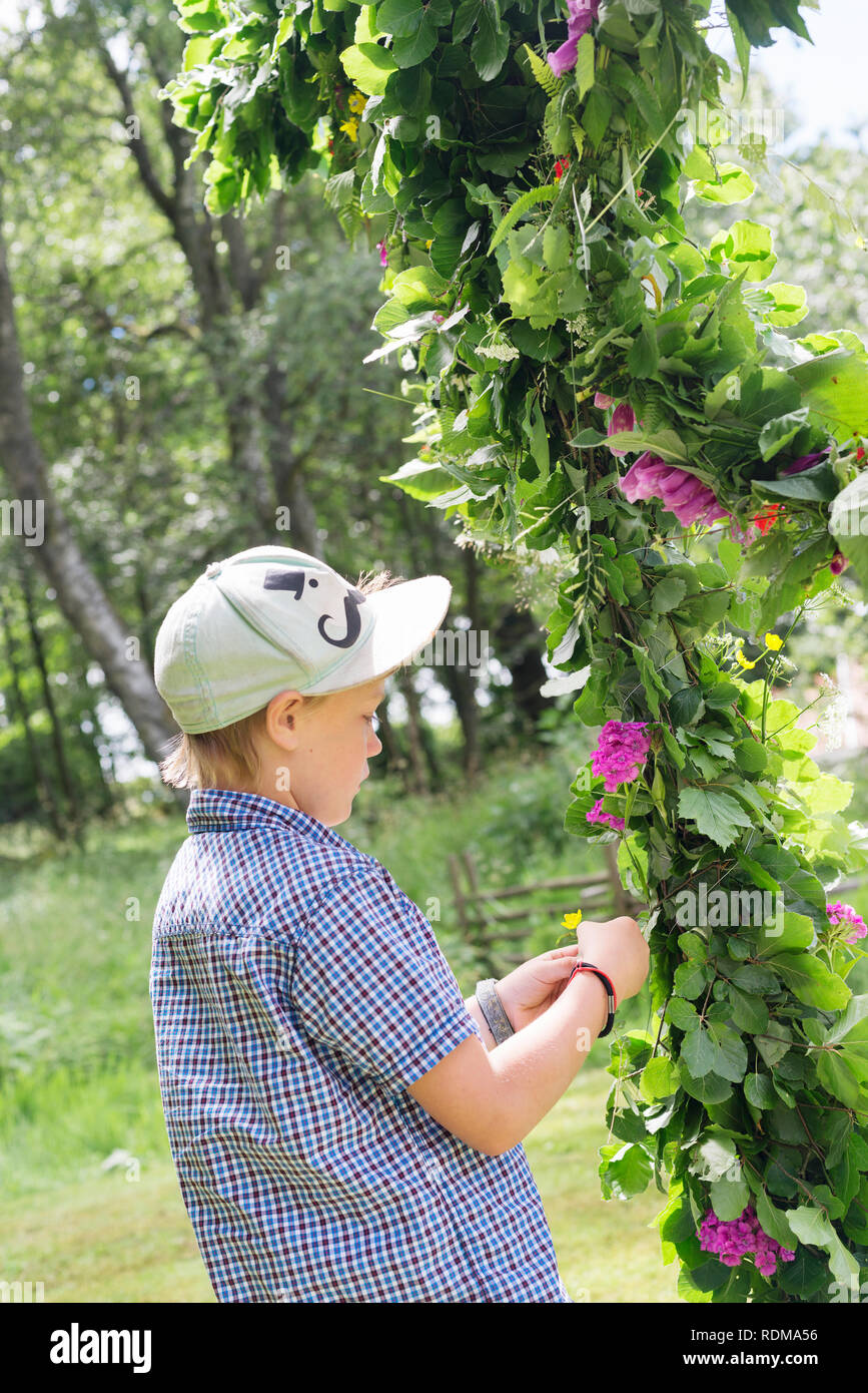 Boy picking up flowers Stock Photo - Alamy