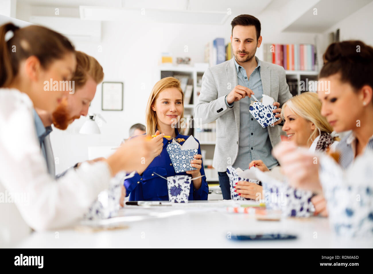 Business people eating in office Stock Photo - Alamy