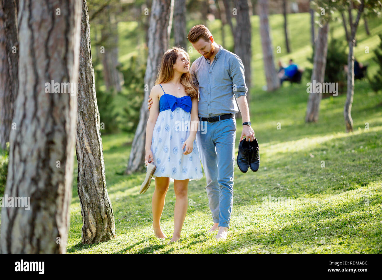 Romantic couple walking forest Stock Photo - Alamy