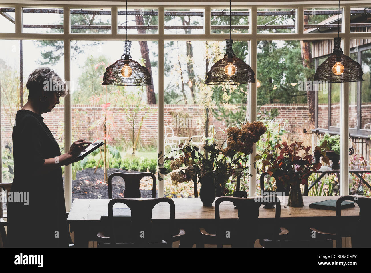 Person standing next table hi-res stock photography and images - Alamy